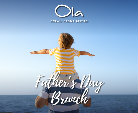 image of son seating on dad's shoulders looking at the ocean