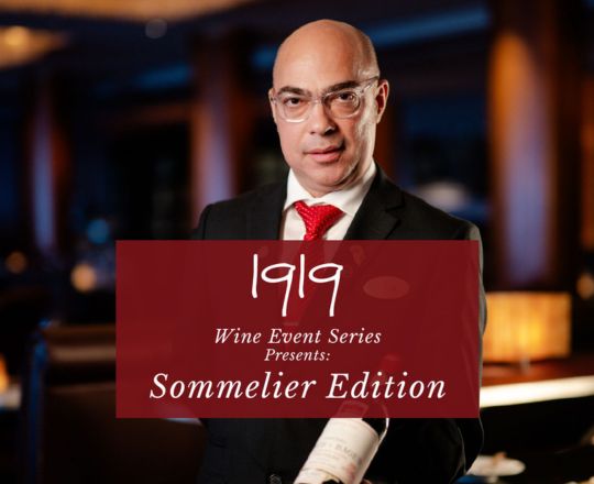 image of sommelier holding a bottle that reads 1919 Wine Event Series presents Sommelier Edition